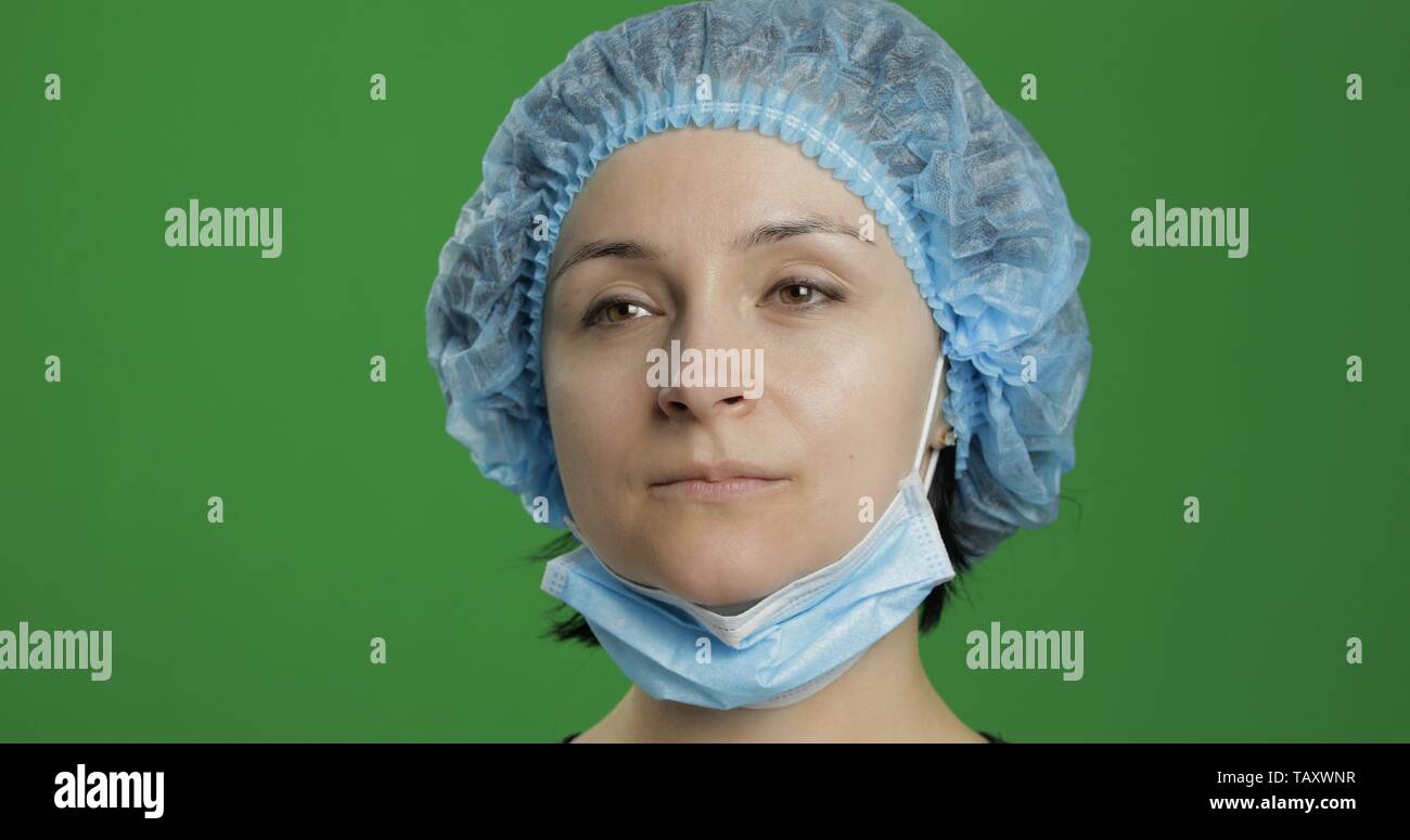 Close-up young doctor. Adult female medical worker in face mask. Chroma ...