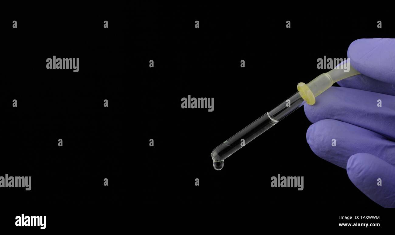 Hand in medical glove drip drop from pipette. Close-up video. Liquid ...