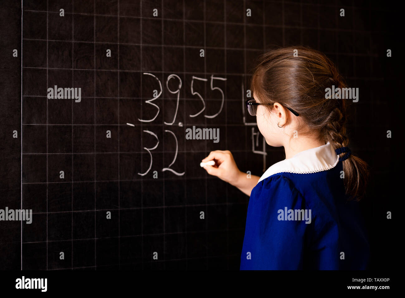 Italian elementary school girl trying to make a long division at the ...