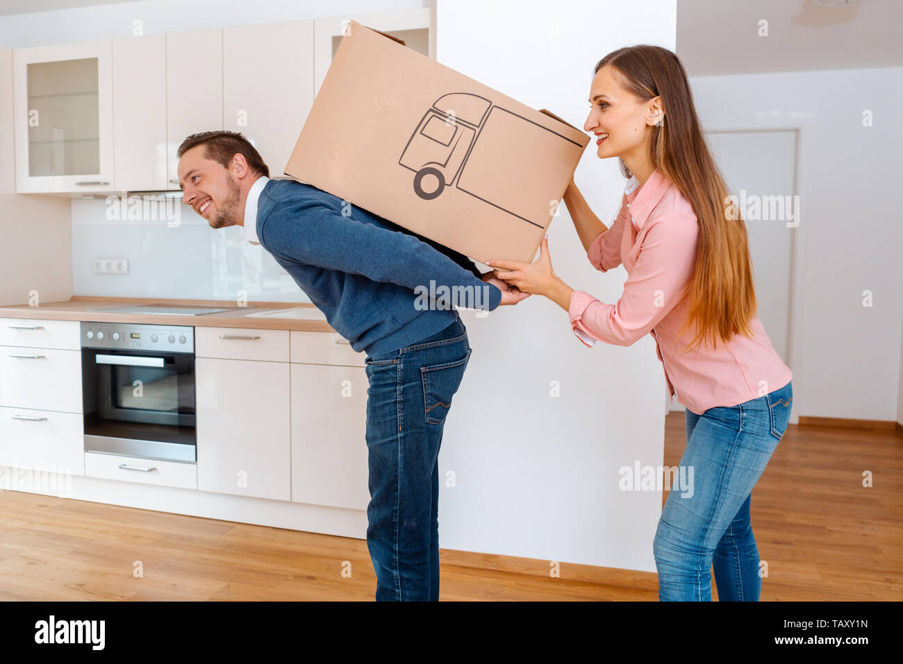 Woman giving her man a moving box Stock Photo - Alamy