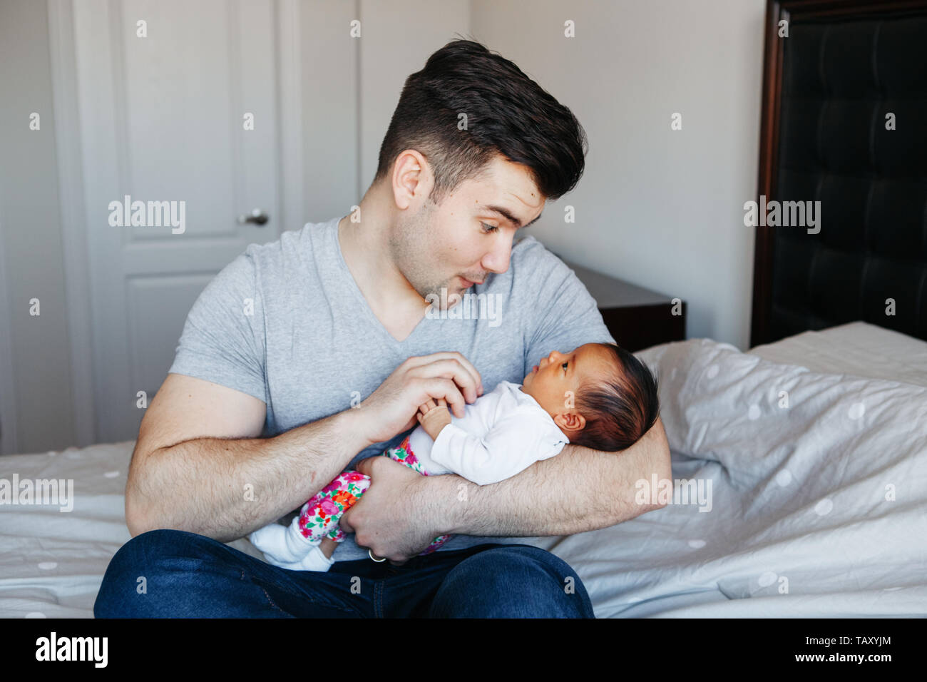 Young Caucasian father dad with his newborn mixed race Asian Chinese ...