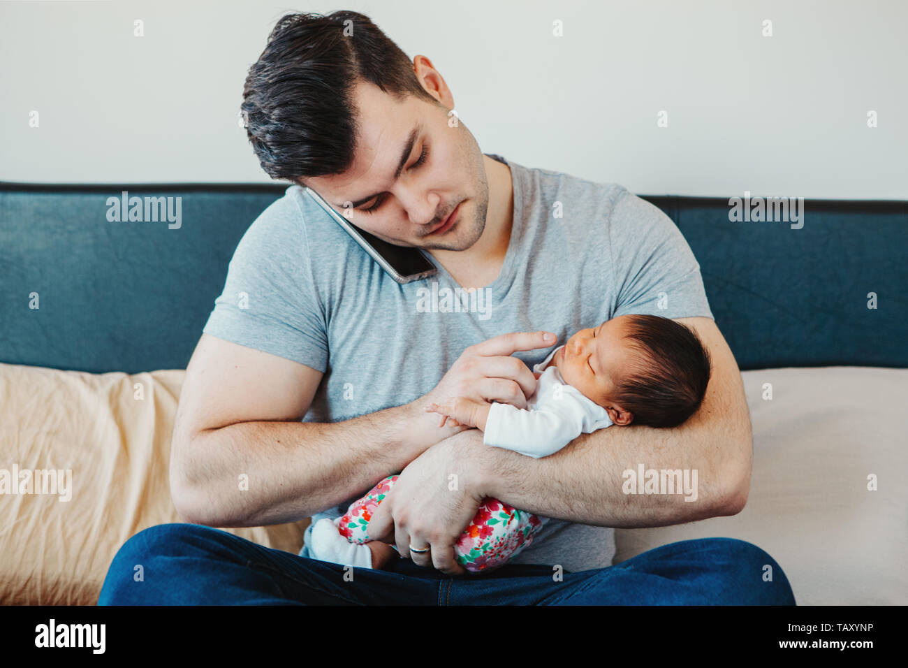 Caucasian father dad with newborn mixed race Asian Chinese baby working ...