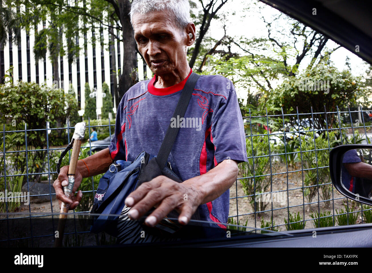 PASIG CITY, PHILIPPINES - MAY 19, 2019: A blind beggar asks for alms or ...