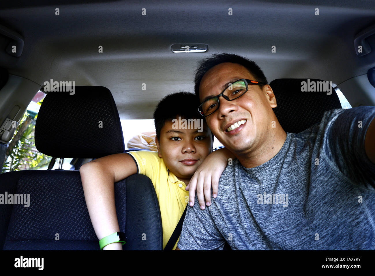Portrait of a young Filipino family inside a car Stock Photo - Alamy