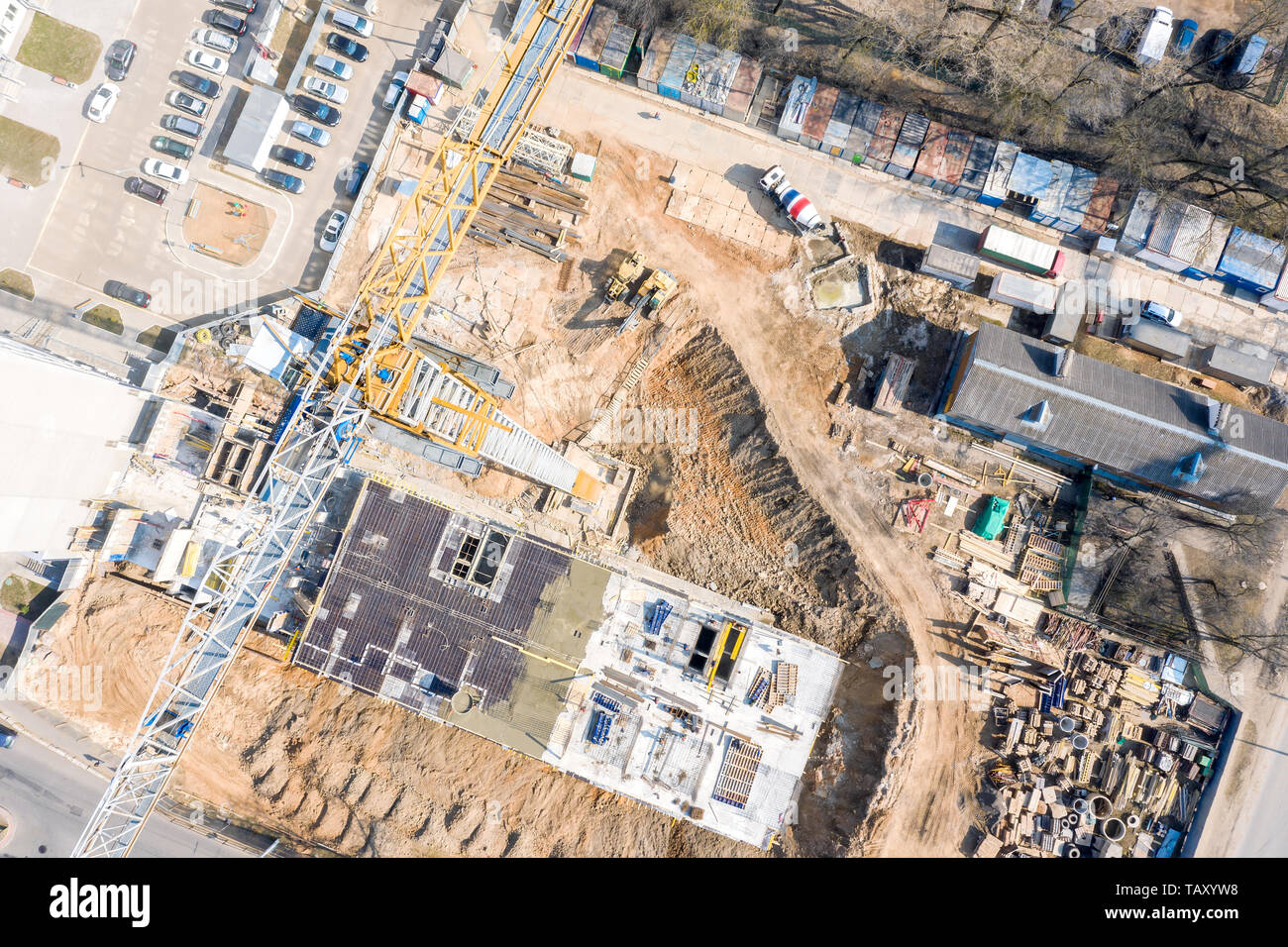 birds eye view of city construction area with tower crane, excavators ...