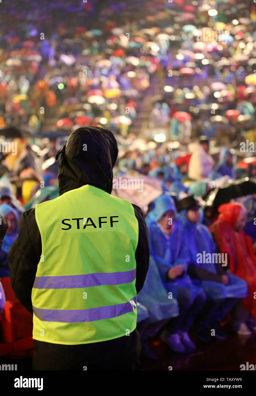 boy with high visibility jacket and refractive inserts with text STAFF ...
