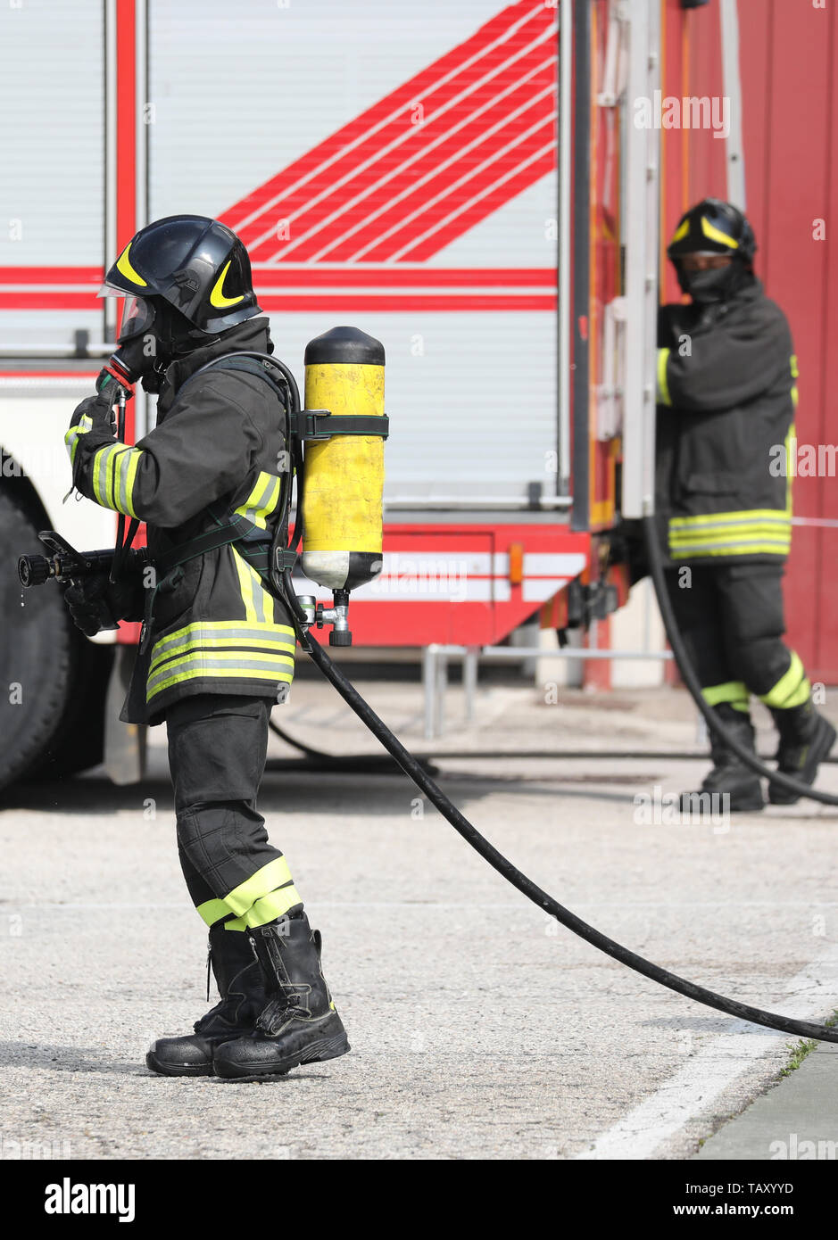 firefighter with apparatus and the fire engine during a fire drill ...