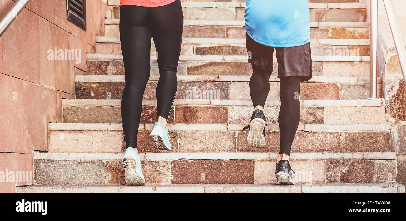 Close up runners legs training outdoor - Young couple doing a workout ...