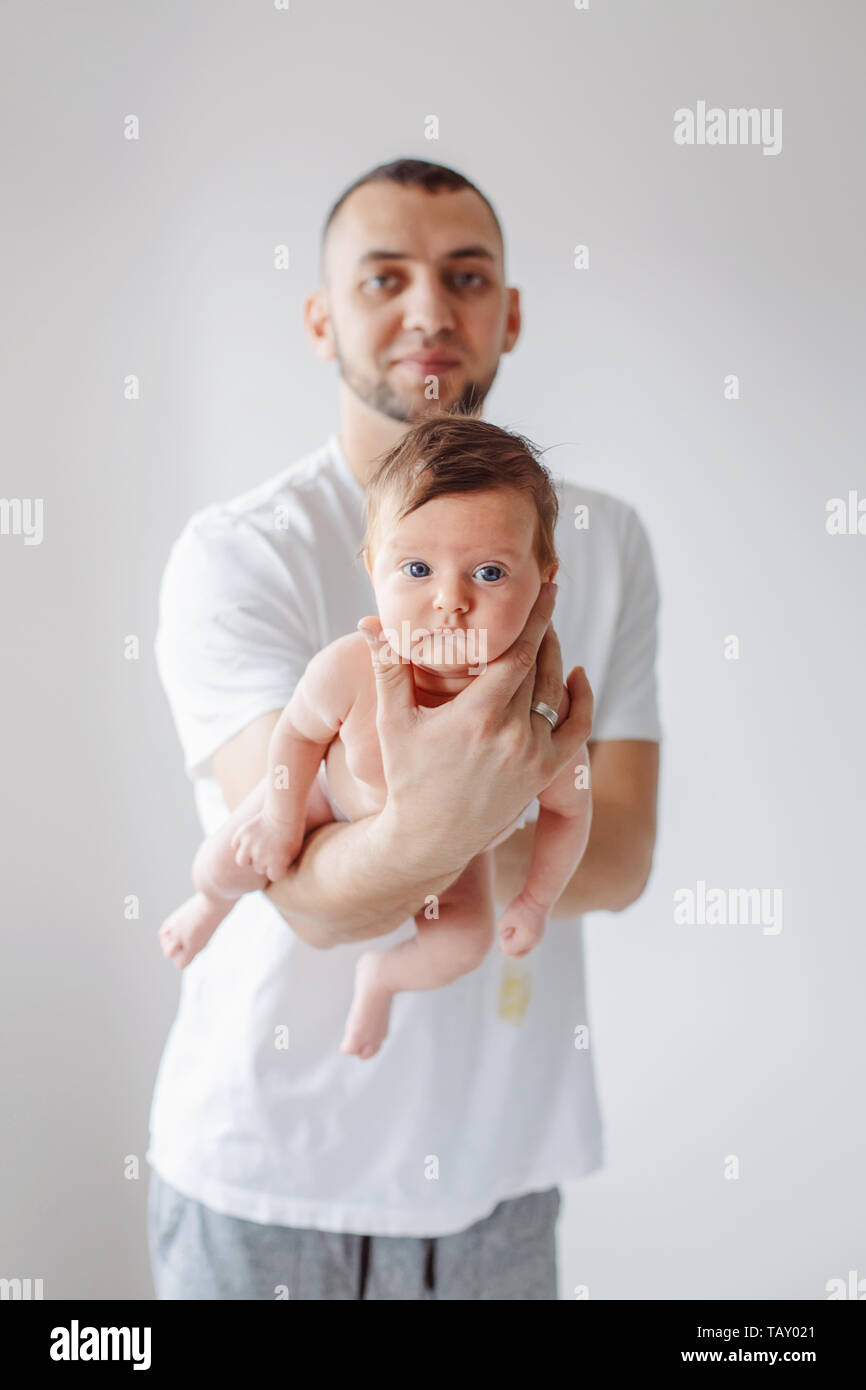 Young Caucasian bearded father holding carrying newborn baby. Male man ...