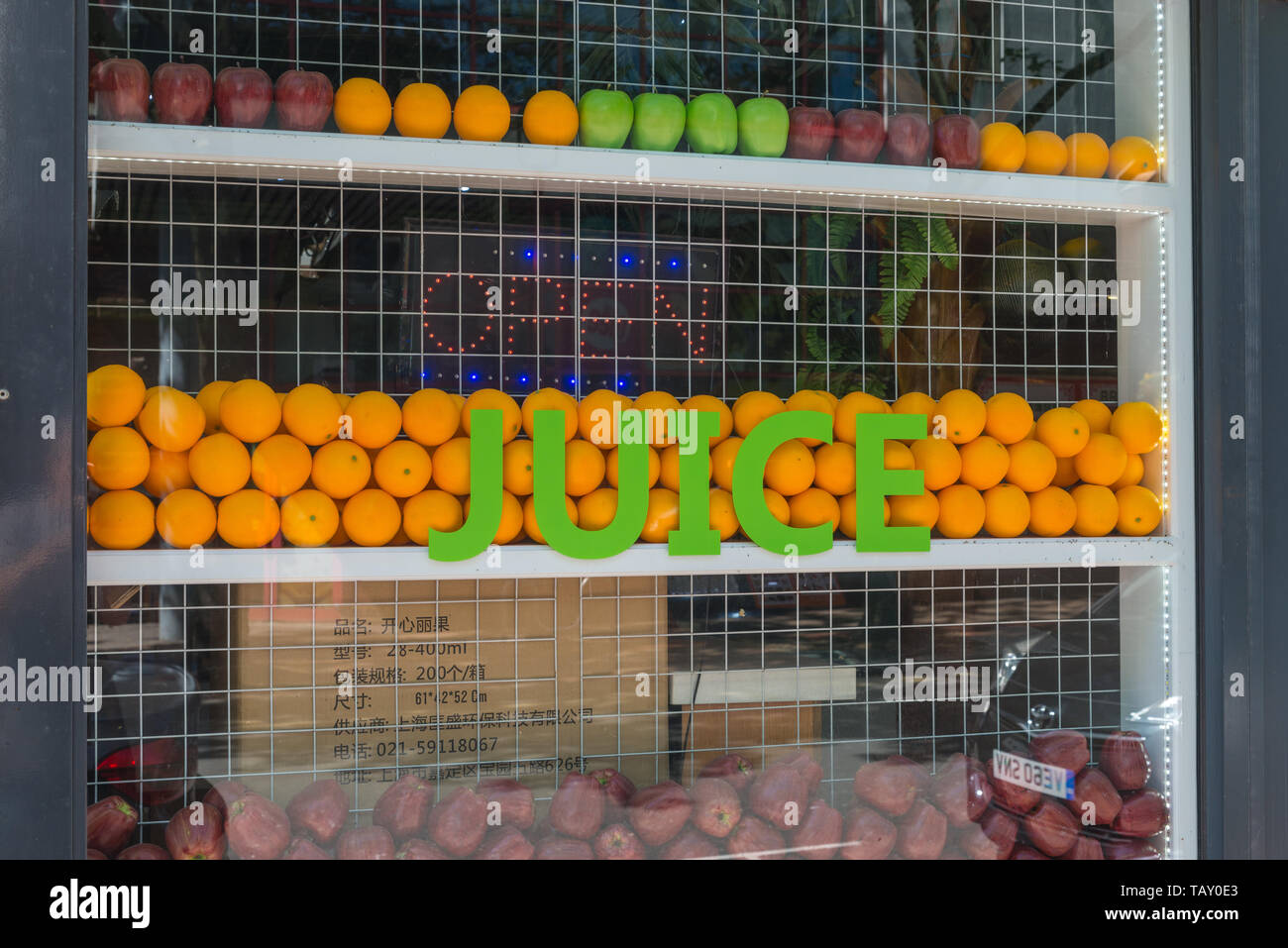 Juice bar with shelves of fresh fruit ready for juicing in the front ...