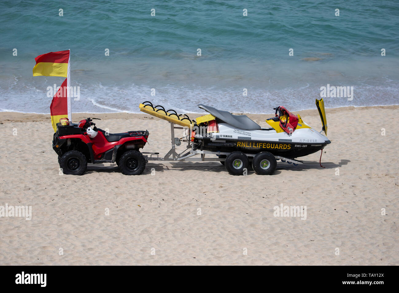 RNLI beach tractor, trailer and rescue boat on the beach at St Ives ...
