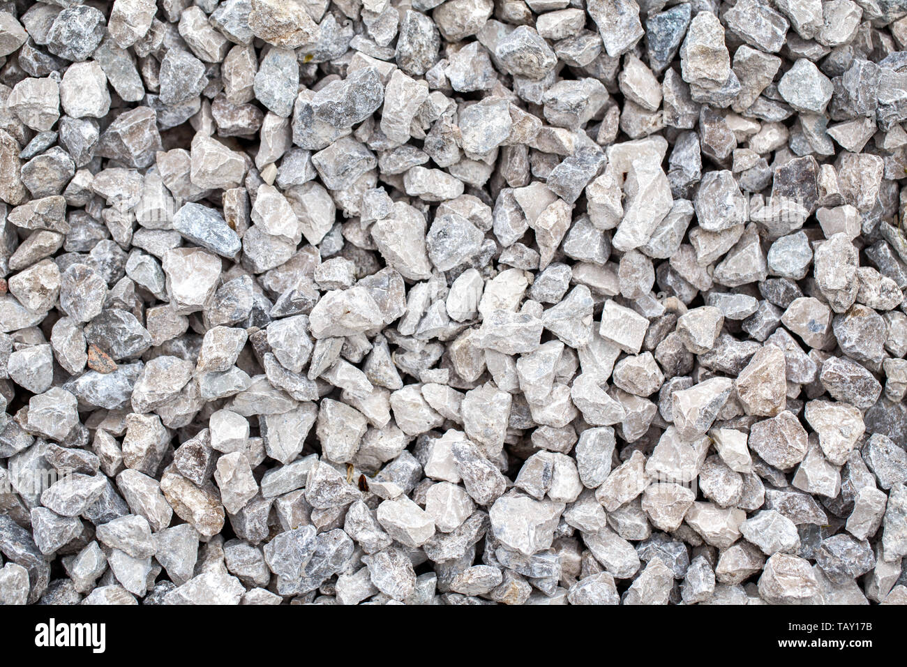 Closeup of small little grey beige blue broken crushed stones rocks ...