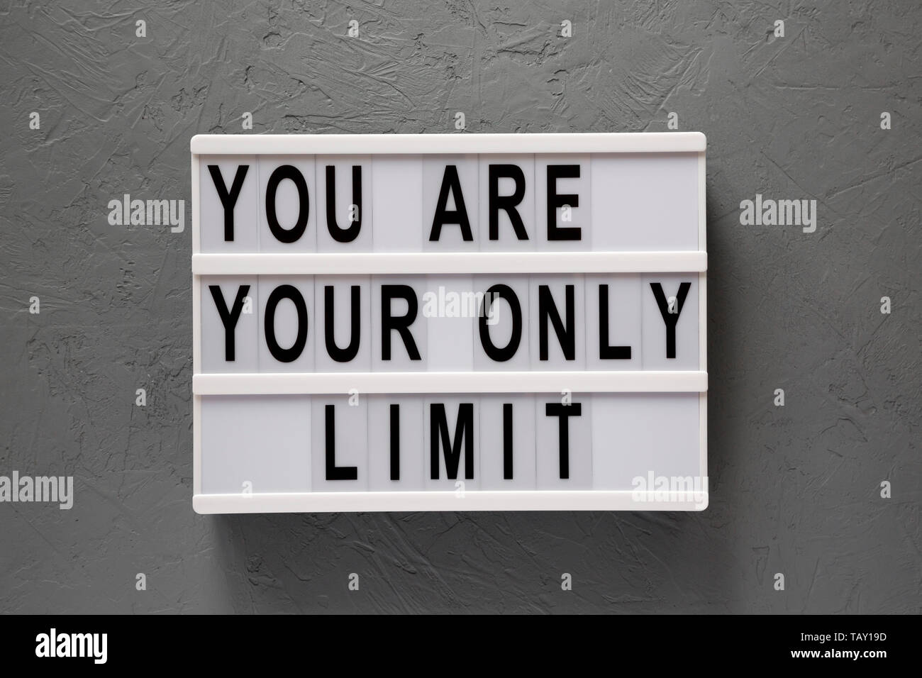 'You are your only limit' words on a modern board over concrete surface ...