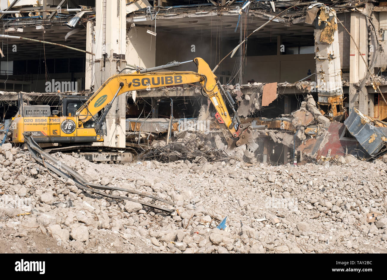 Excavator demolishing a factory Stock Photo - Alamy