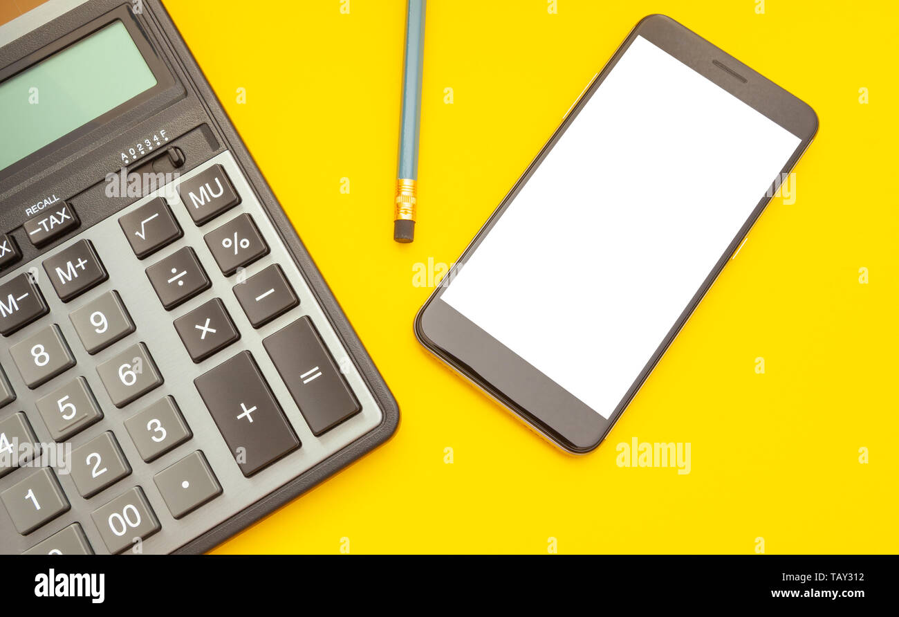 Modern calculator and phone with space for text on a yellow background ...