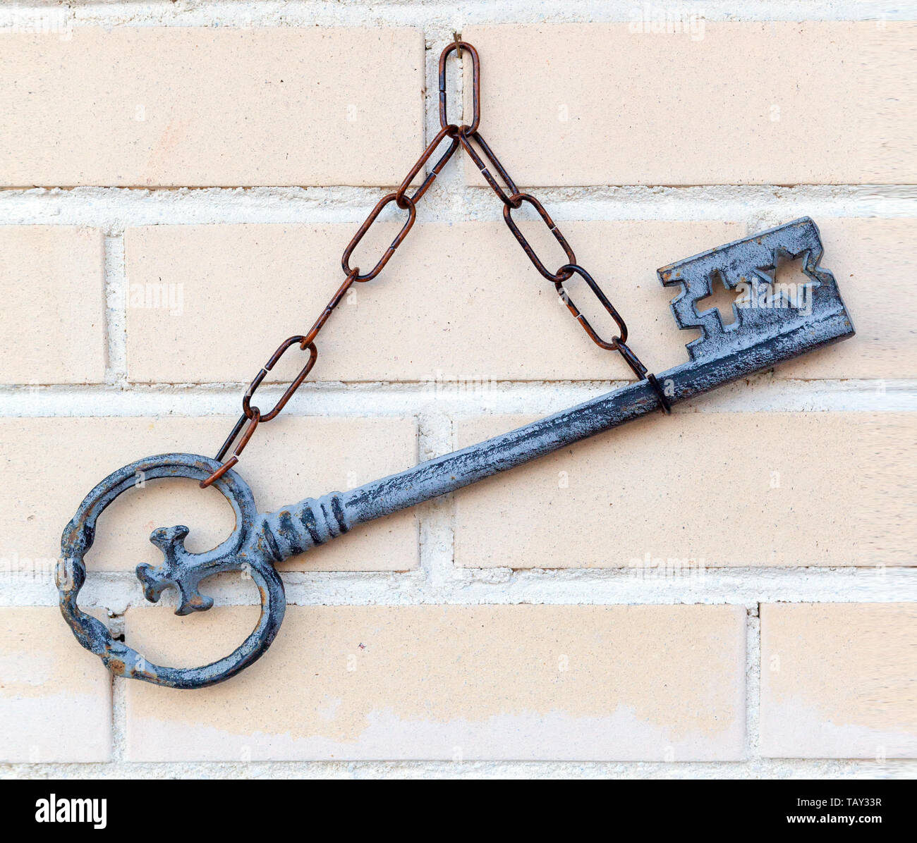 Vintage key on brick wall background, home decor Stock Photo - Alamy