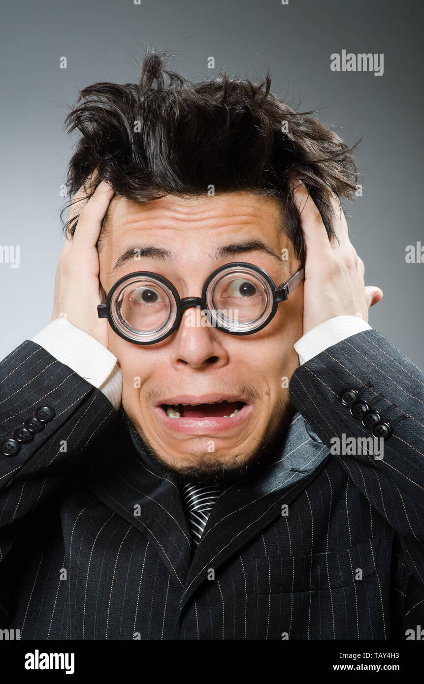 Funny nerd businessman in dark studio Stock Photo - Alamy