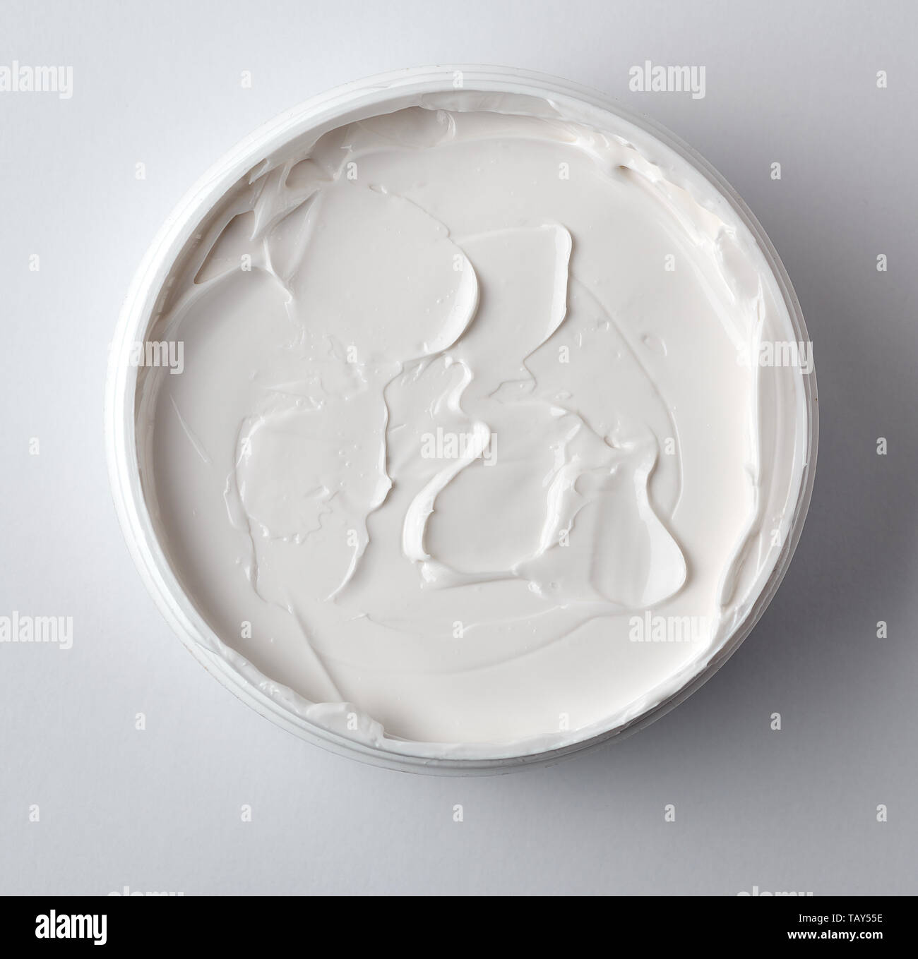 thick white cosmetic cream in a plastic jar, top view, white background ...