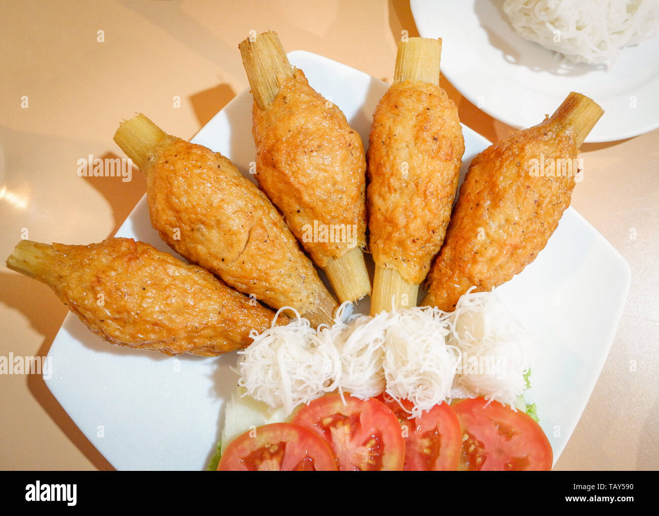Fried Shrimp with Sugar Cane with rice noodle and tomato on plate thai ...