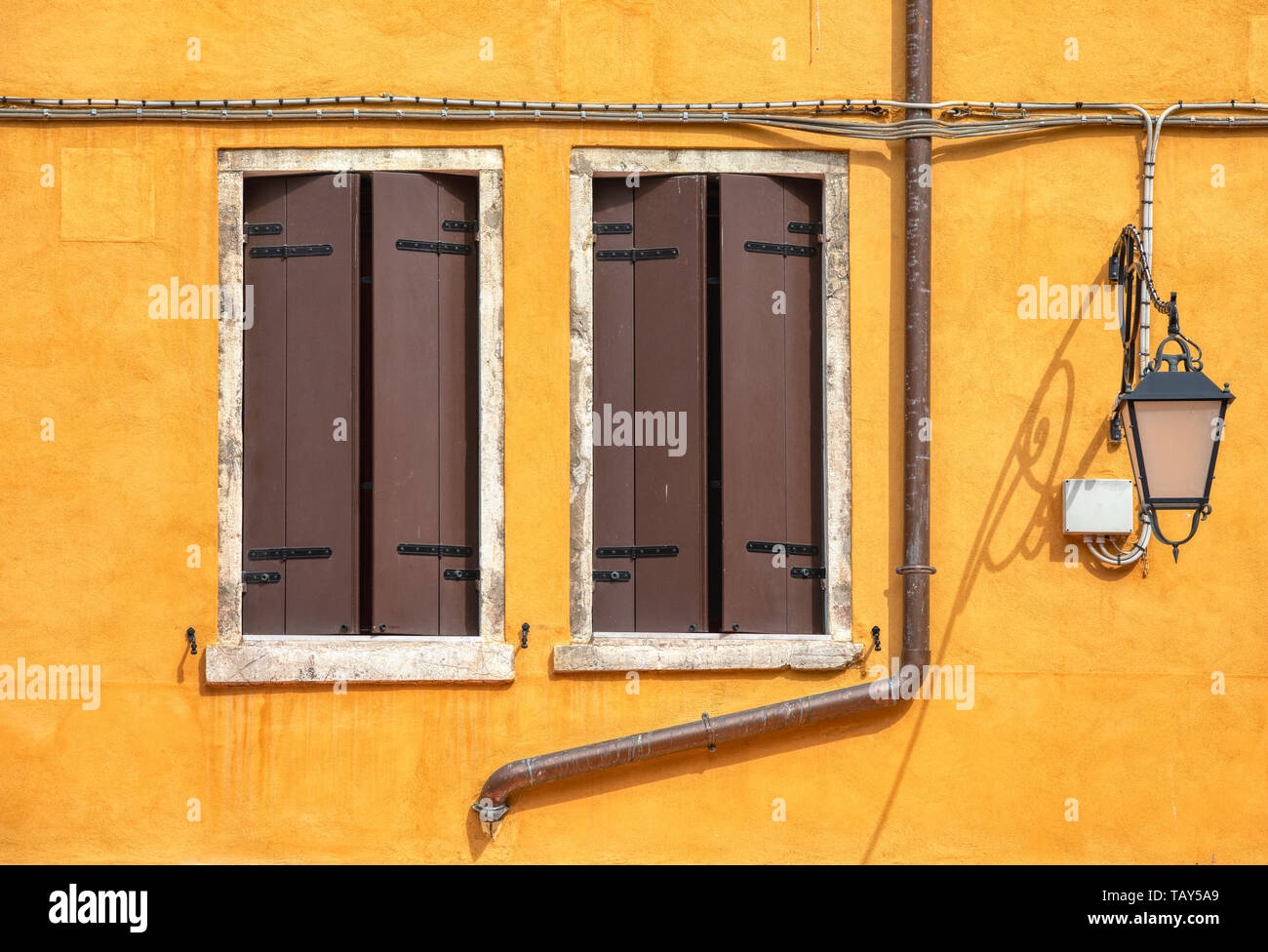 Photograph taken of two brown closed window shutters in the medieval ...