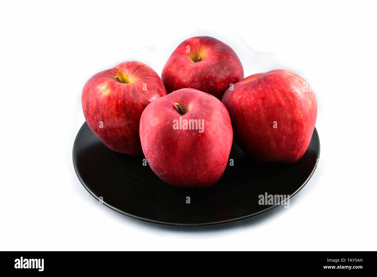 fresh red apple on black plate isolated on white background Stock Photo ...