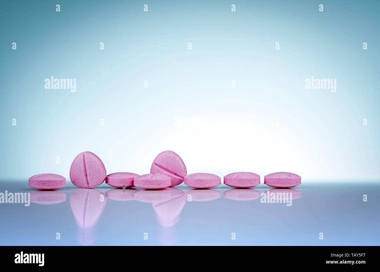 Pink tablets pills with shadow on gradient background. Pharmaceutical ...
