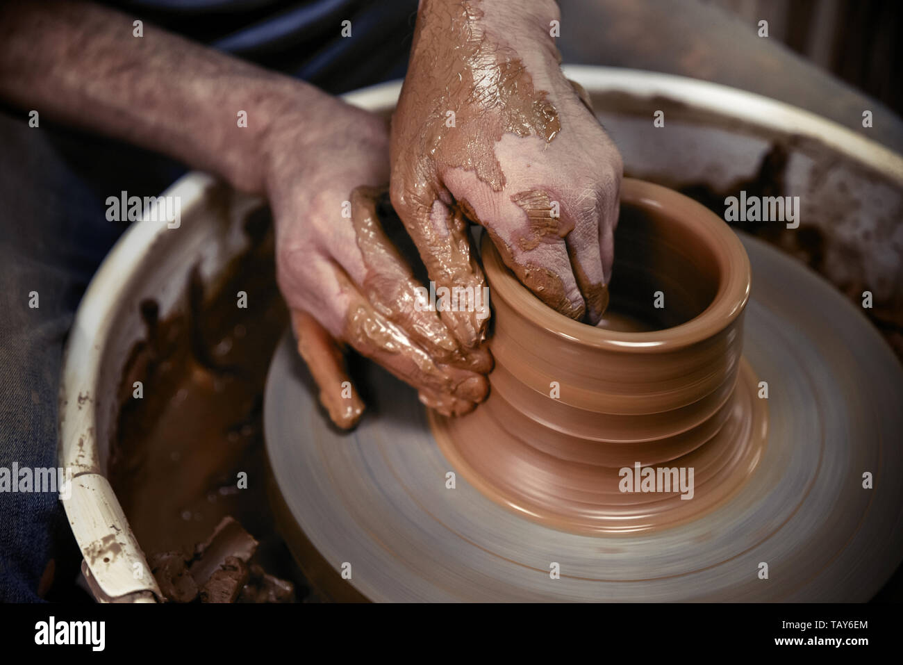 Pottery. The master at the potter's wheel, produces a vessel of clay ...