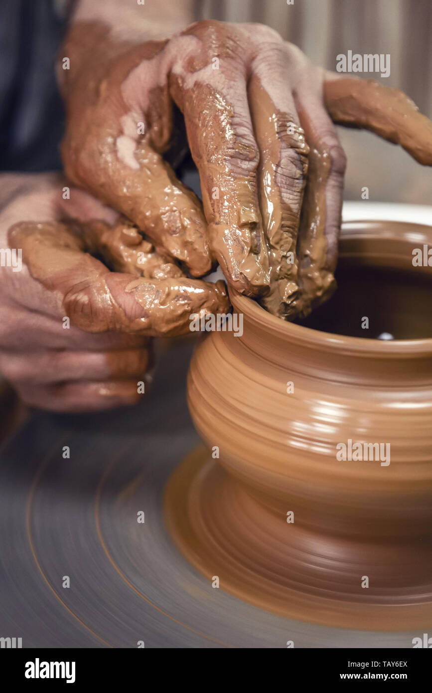 Pottery. The master at the potter's wheel, produces a vessel of clay ...