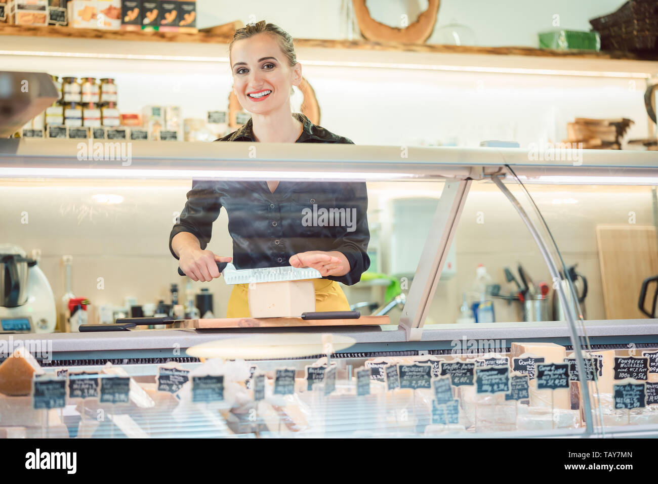 Women selling cheese at counter in a supermarket Stock Photo - Alamy