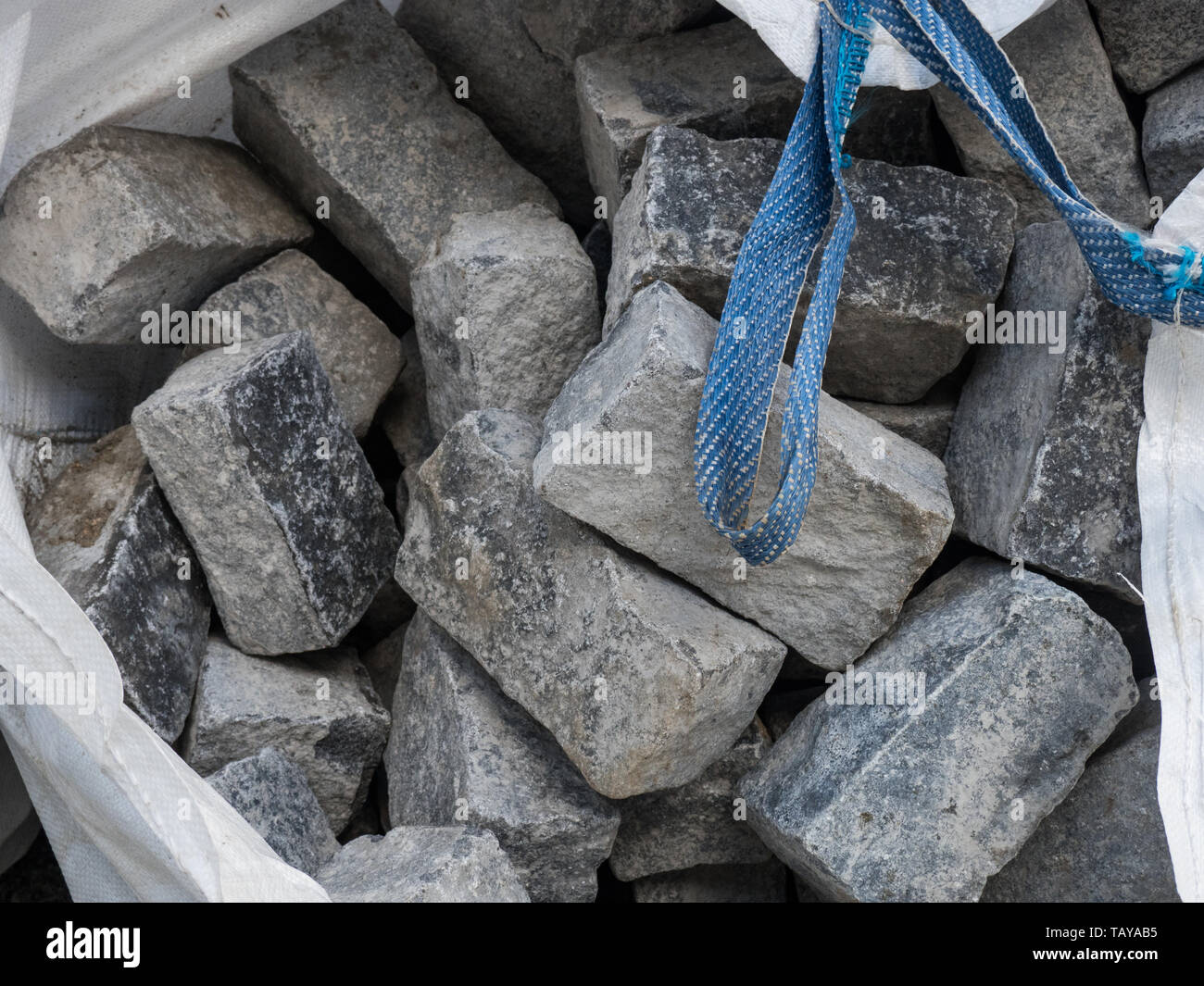 Grey stone bricks in a big bag Stock Photo - Alamy