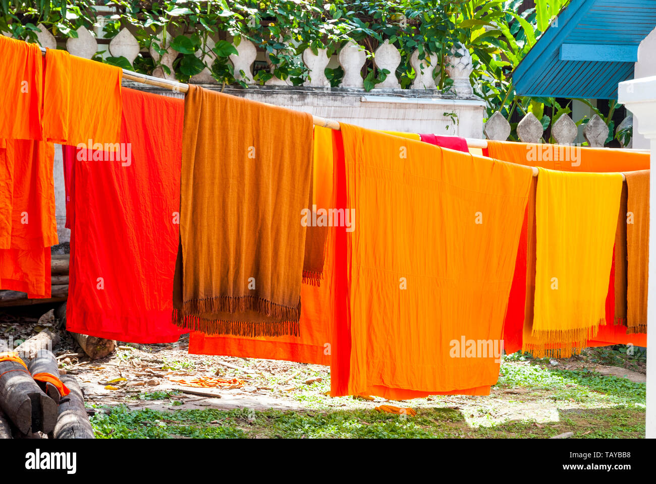 Orange clad robes aka. buddhist monks clothes drying outside, Laos ...