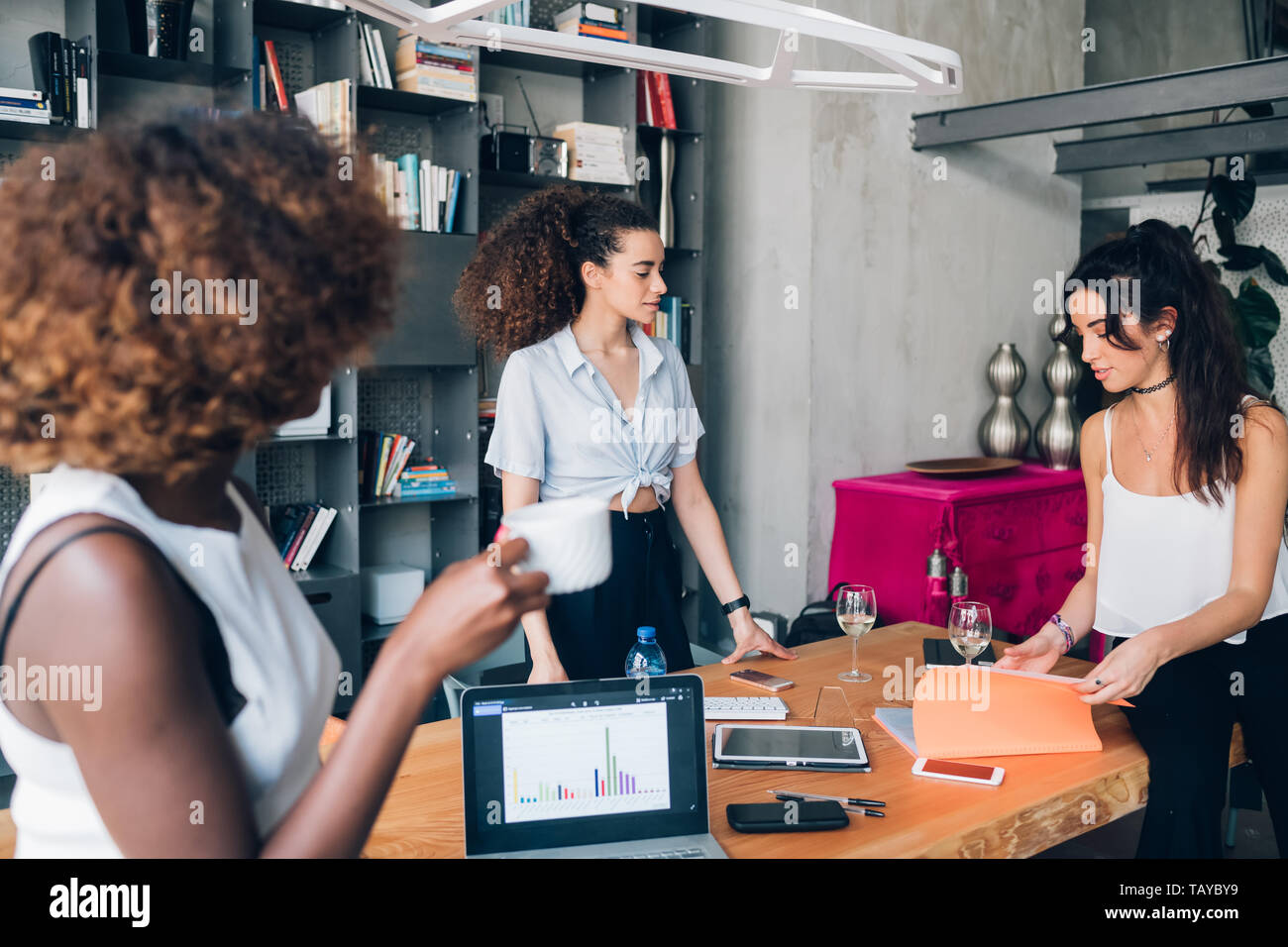 young multiracial freelancer having informal talk in coworking office ...
