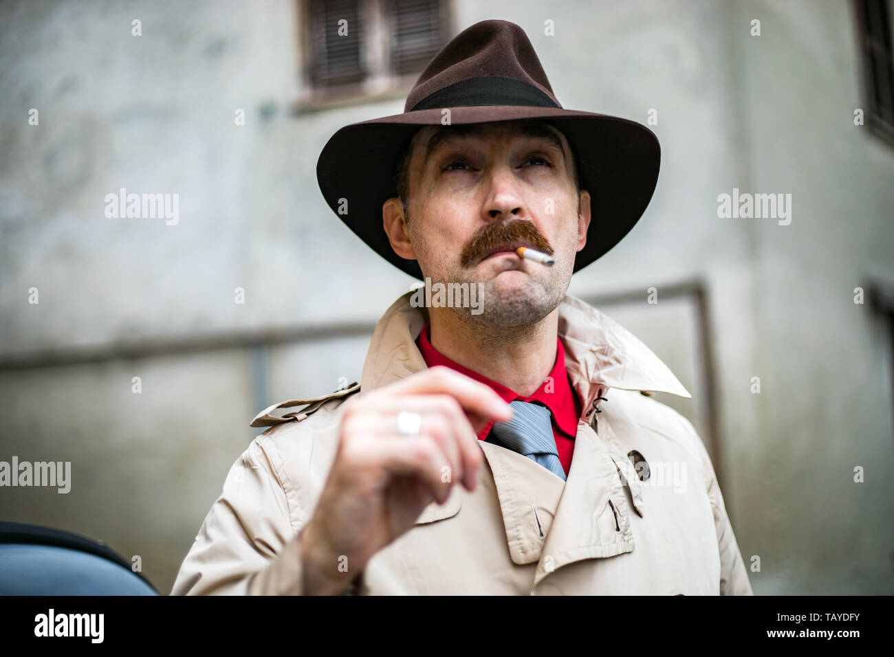 Vintage detective smoking a sigarette ina city slum Stock Photo - Alamy
