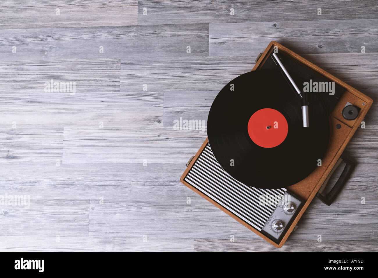Vintage Gramophone with a vinyl record on gray wooden table, top view ...