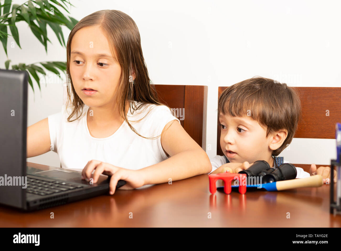 Happy Girl and Boy Sitting at his Desk With Laptop Computer Stock Photo ...