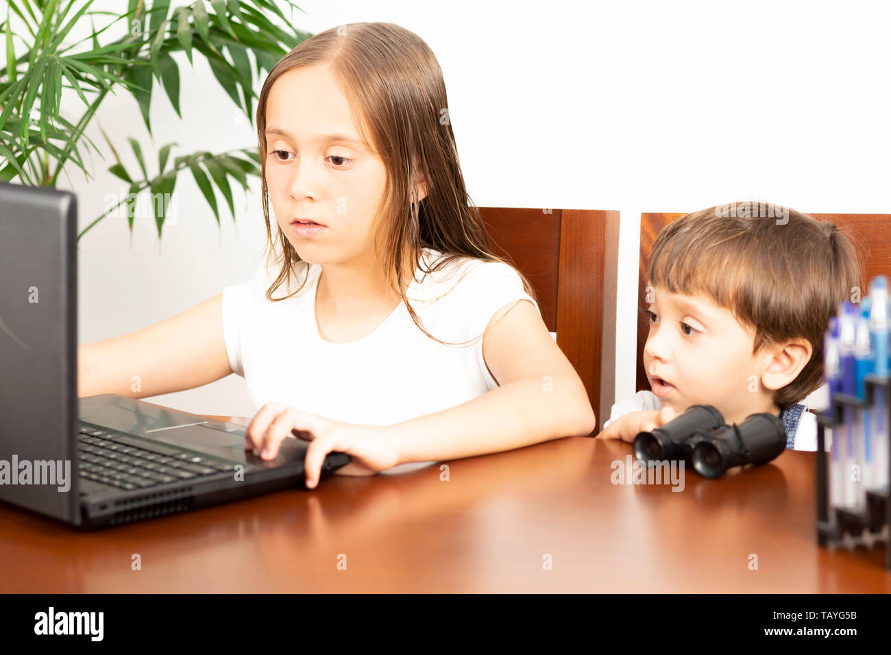Happy Girl and Boy Sitting at his Desk With Laptop Computer Stock Photo ...