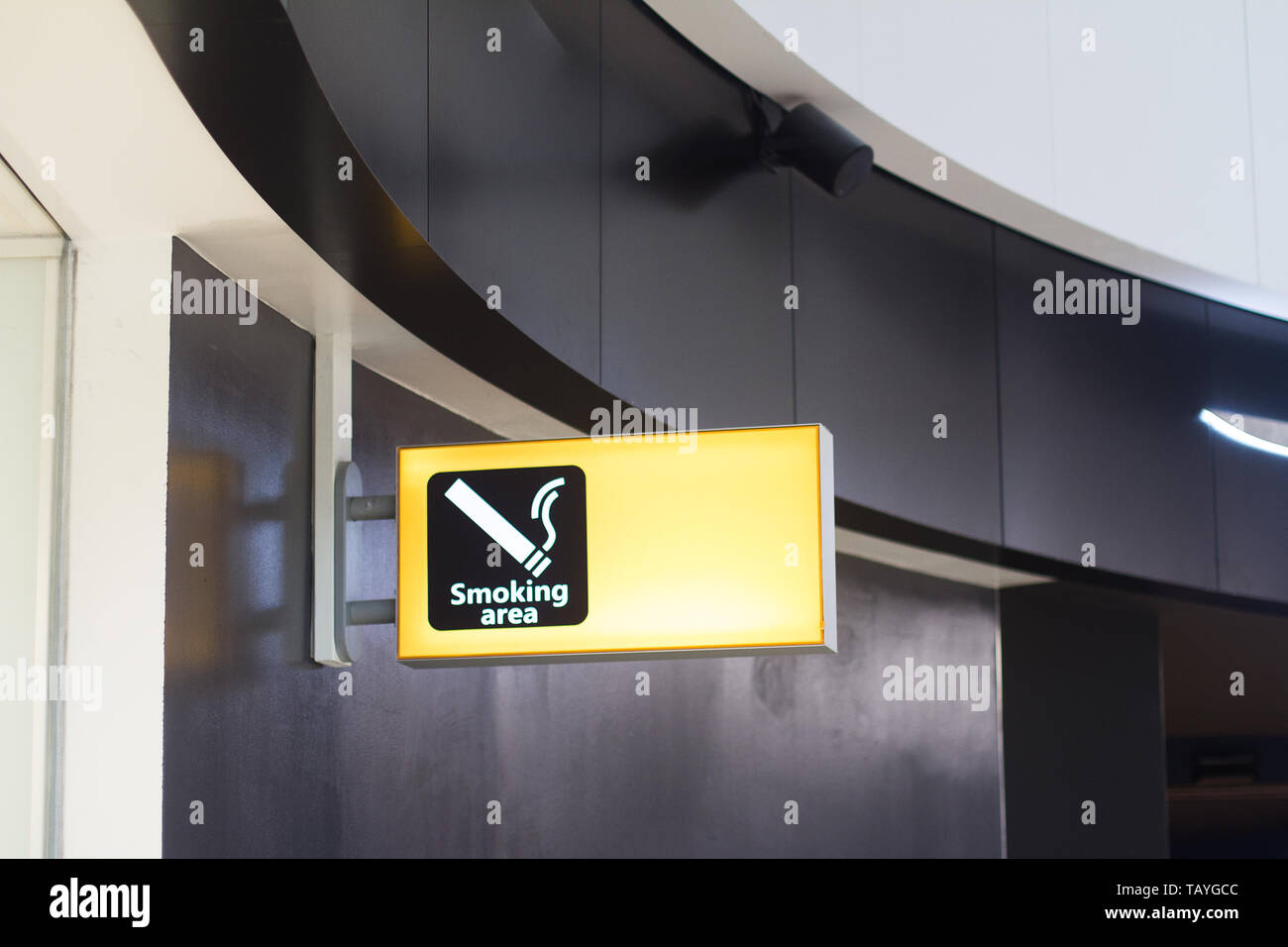 front view closeup of yellow smoking sign area signage in a business ...