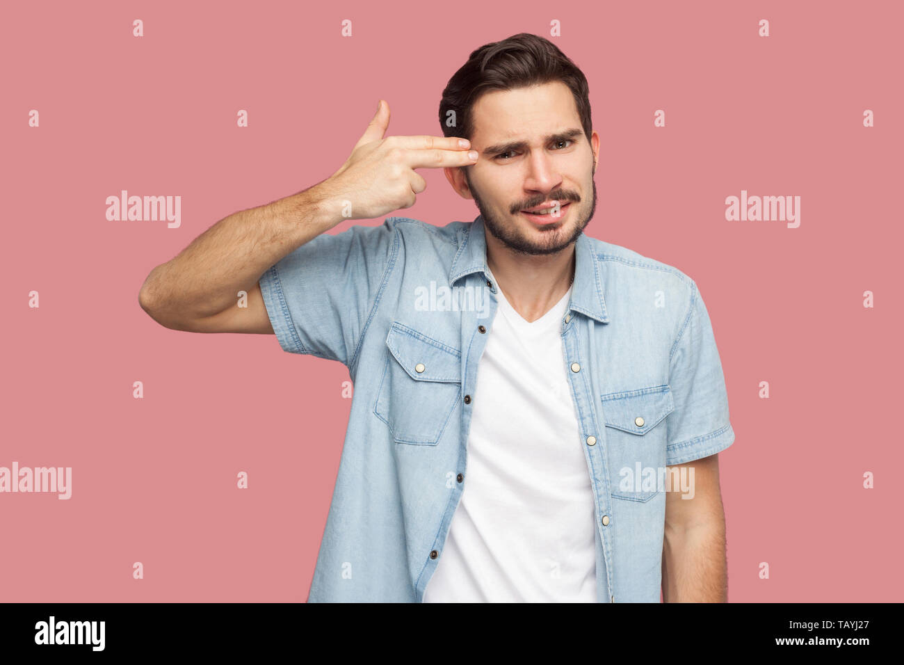 Portrait of crazy sad bearded young man in blue casual style shirt ...
