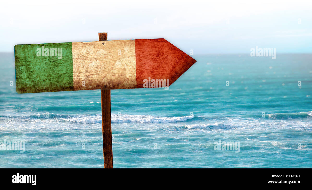 Italy flag on wooden table sign on beach background. There is beach and ...