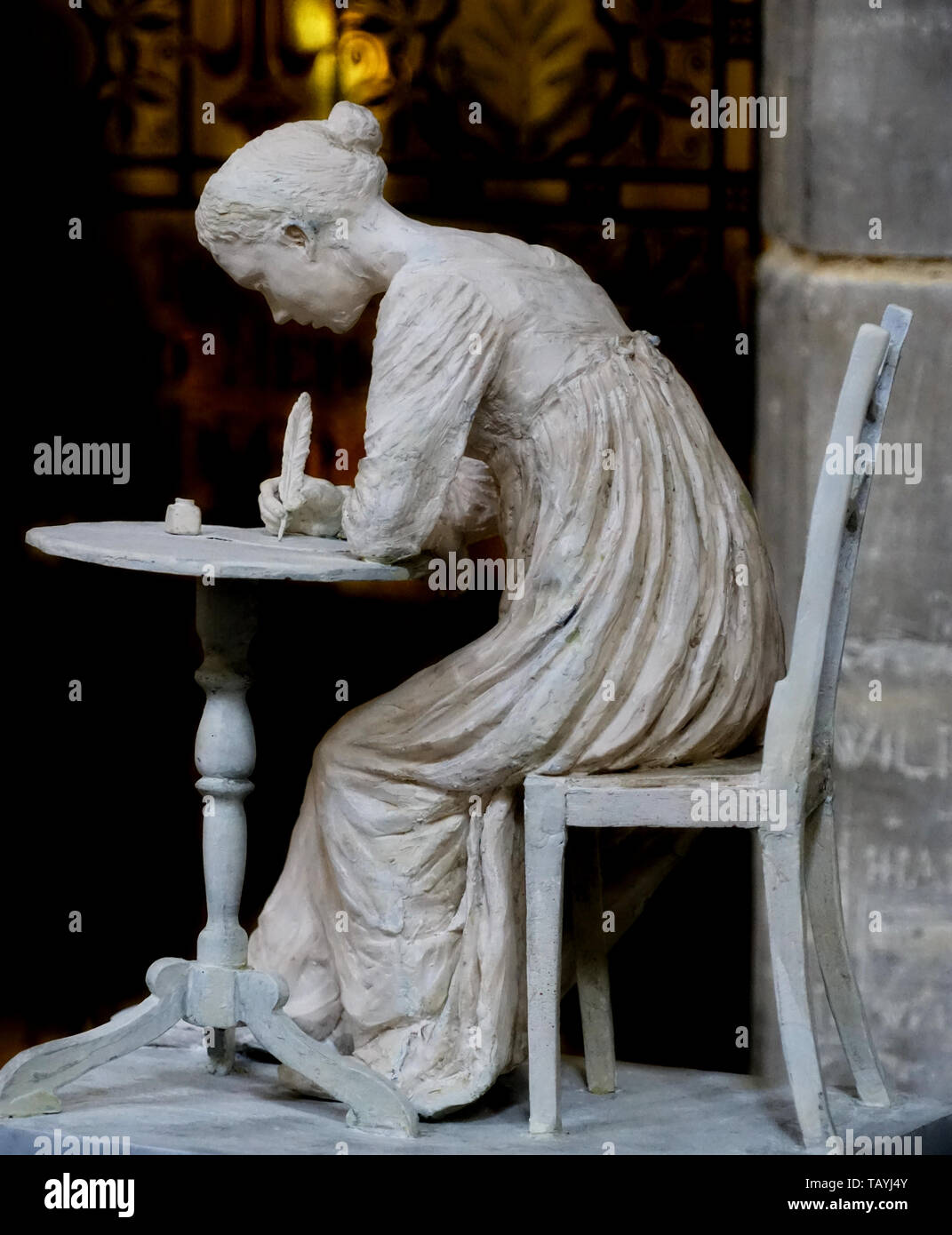 Statuette of Jane Austen at her writing table in Winchester Cathedral ...