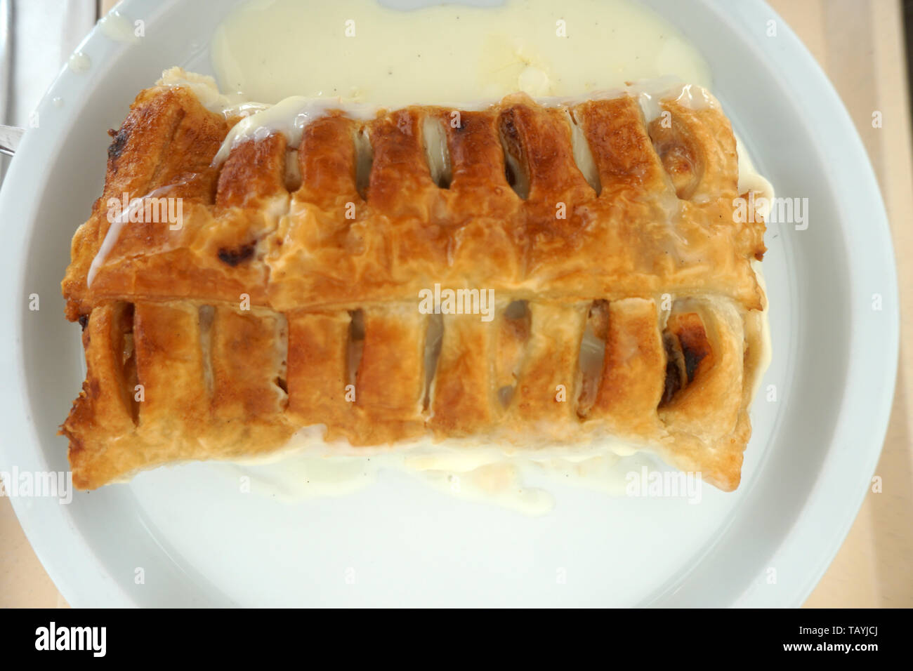 Delicious apple strudel with custard and fruit salad in a canteen in ...
