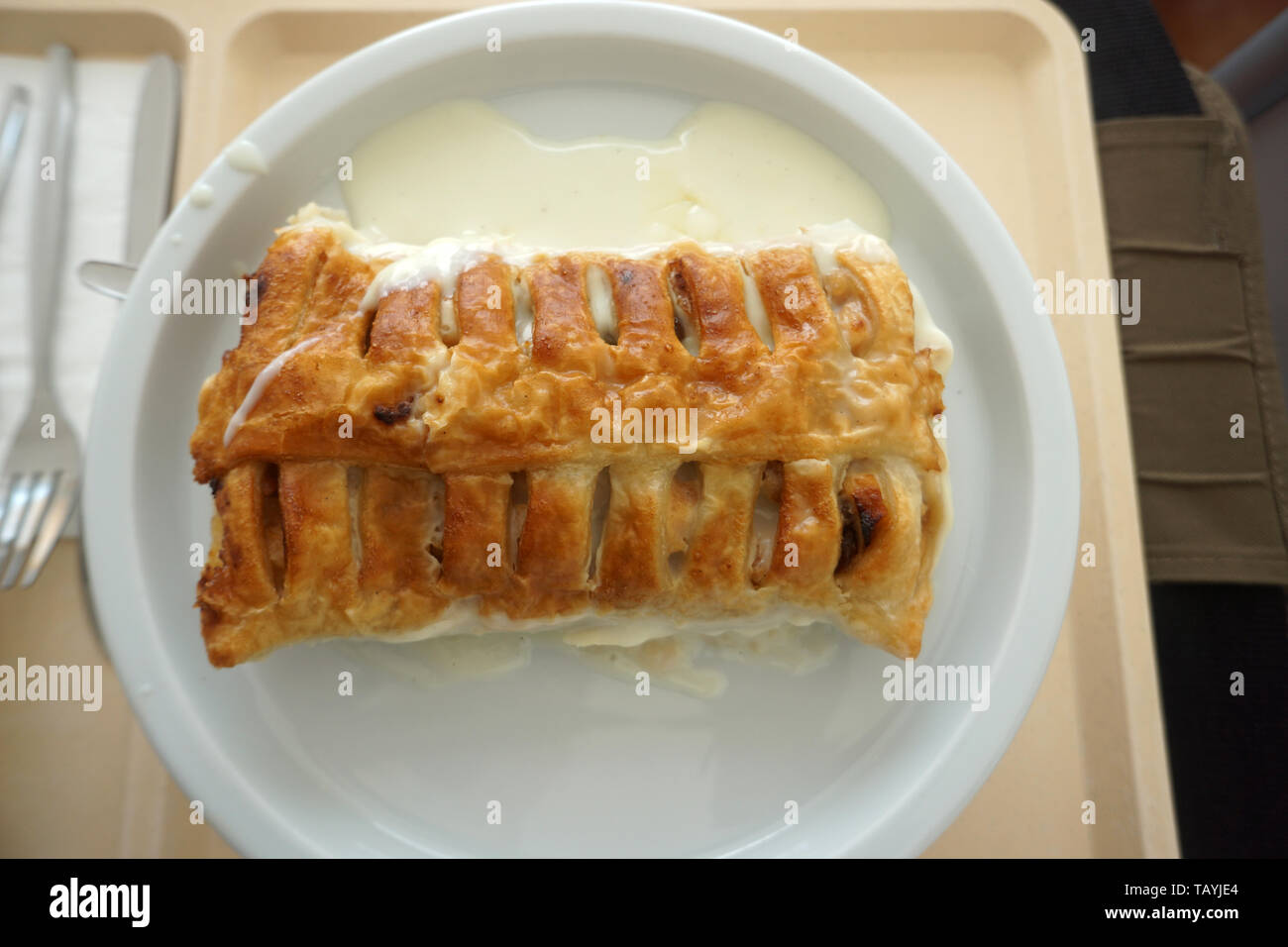 Delicious apple strudel with custard and fruit salad in a canteen in ...