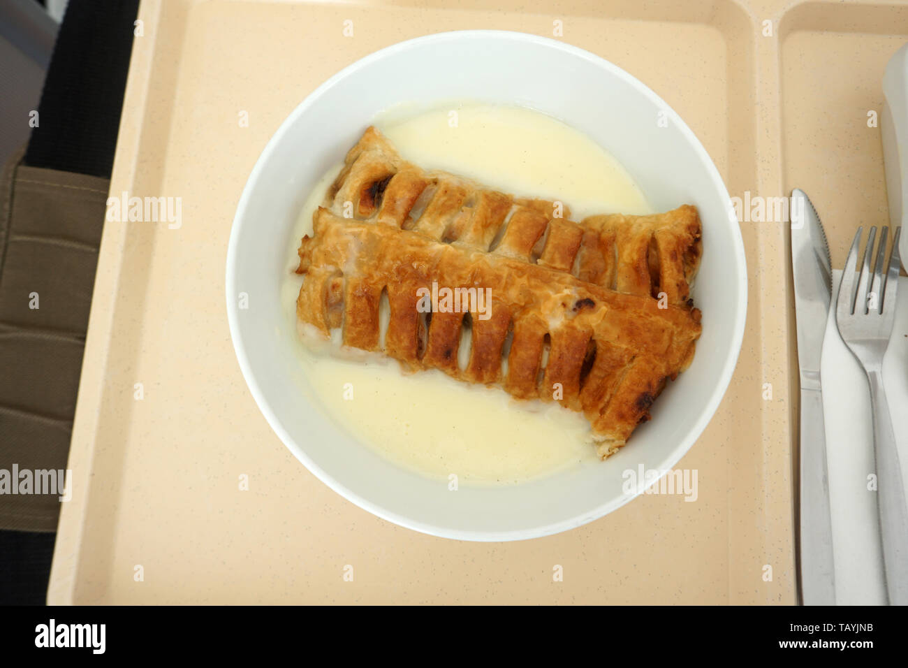 Delicious apple strudel with custard and fruit salad in a canteen in ...