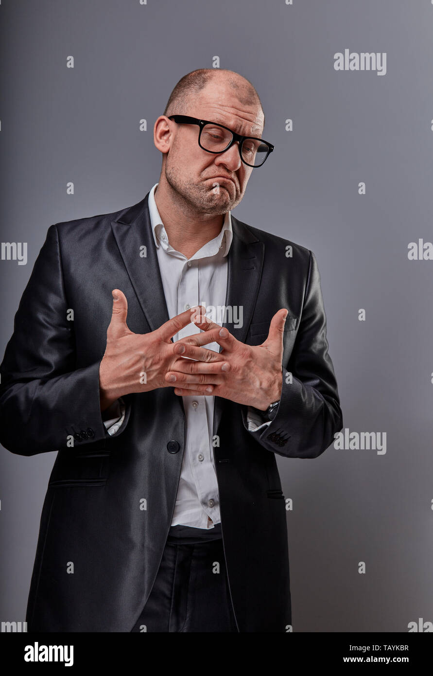 Unhappy doubt busuness man in black suit and glasses showing the palm ...
