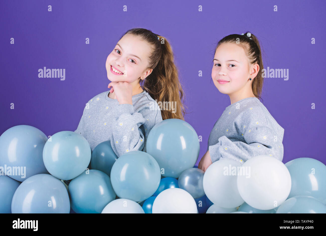 Party is on. Happy children playing with air balloons. Using balloons ...