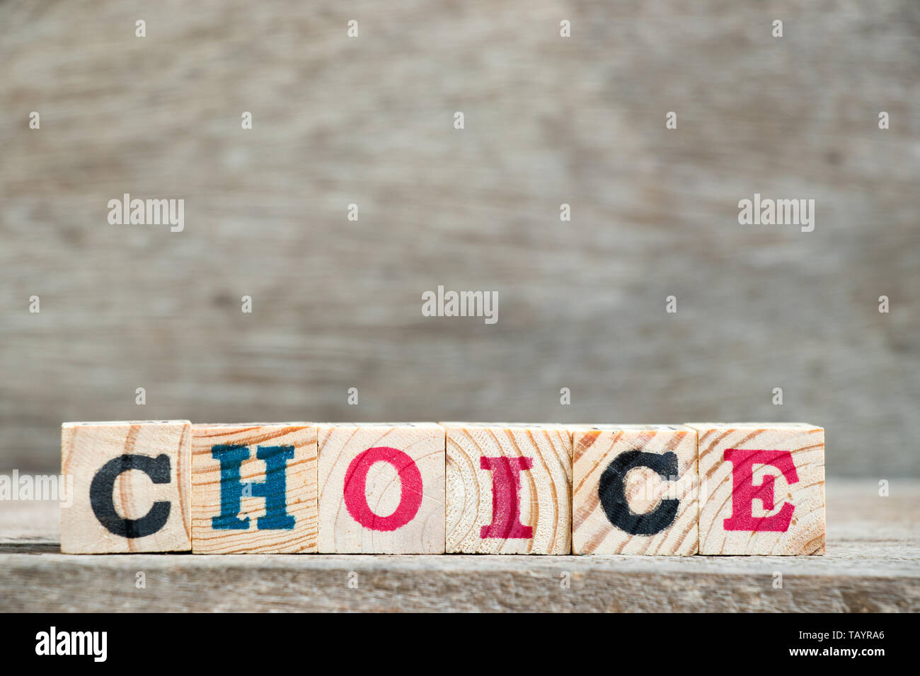 Letter block in word choice on wood background Stock Photo - Alamy