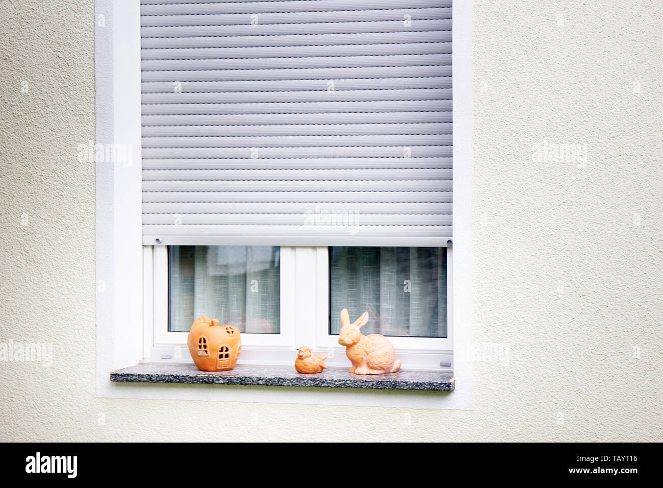 Window under a canopy of greenery. Window of lodging sill decorated ...