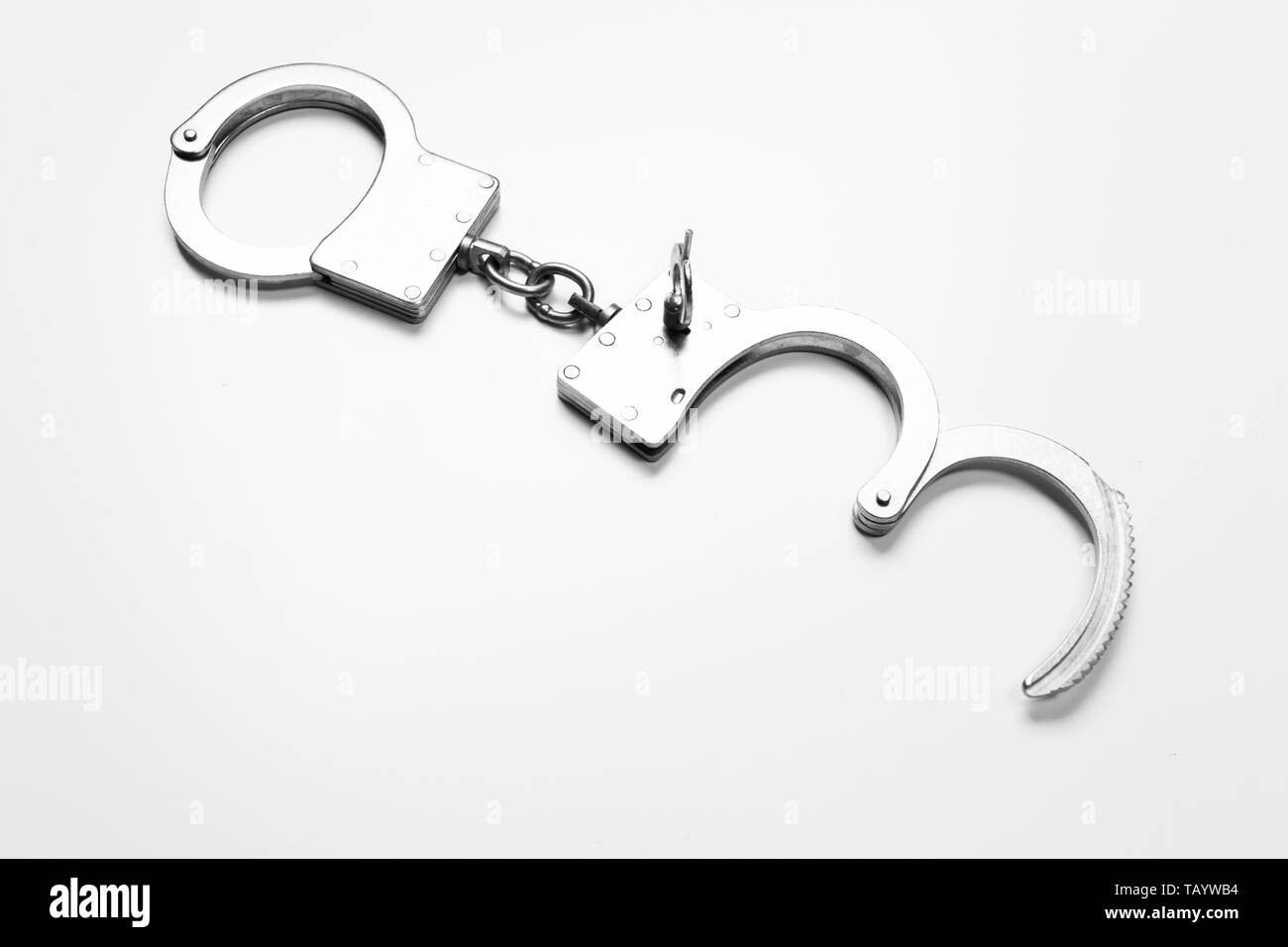Closed handcuffs white background Black and White Stock Photos & Images ...