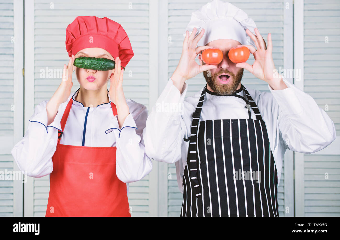 Healthy cooking. Couple of cooks having fun with natural healthy food ...