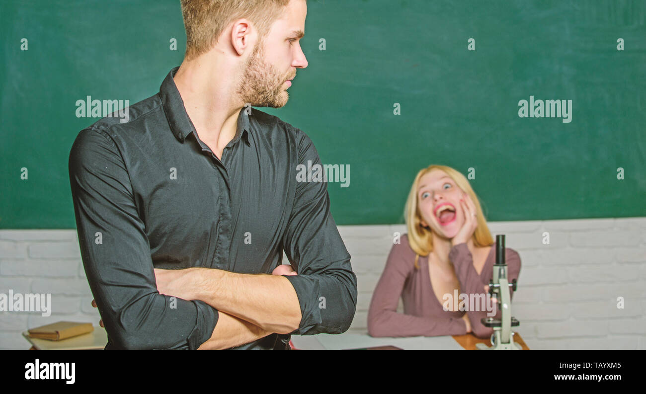 Answering home assignment. Male student with examiner at examination ...